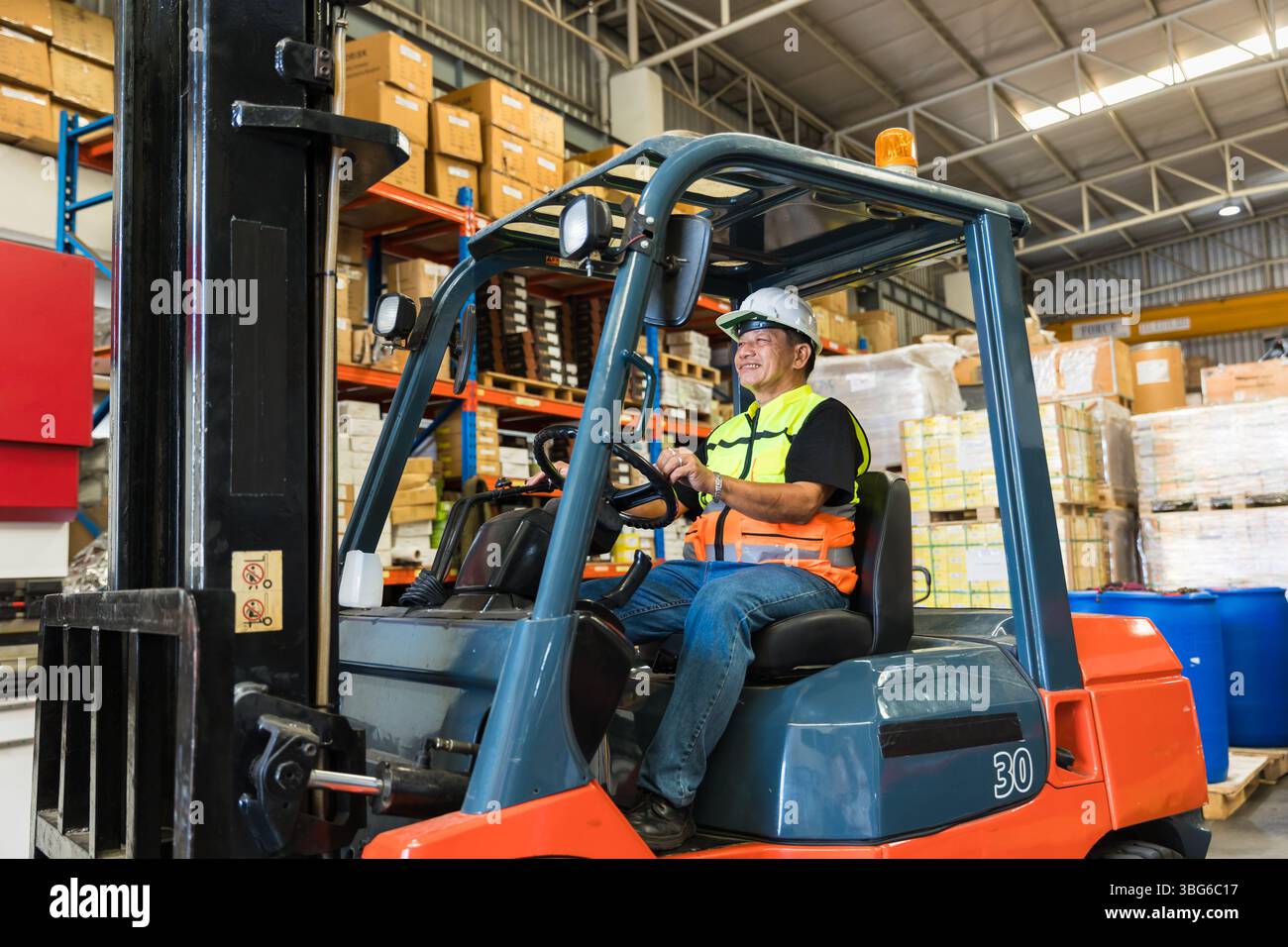 warehouse worker man forklift driver happy smiling enjoy staff working. asian male factory cargo ...
