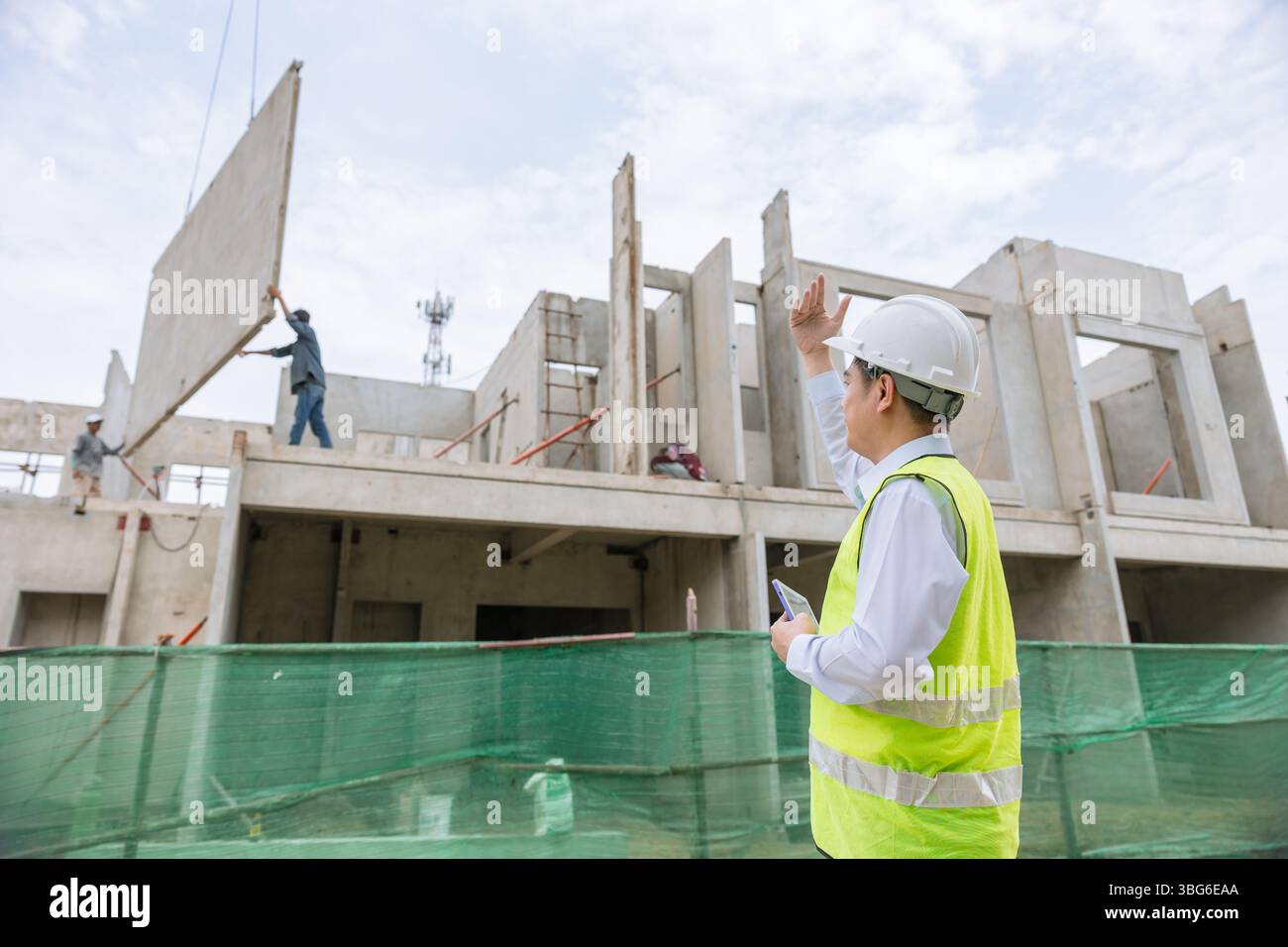 Concrete precast building, Construction engineer foreman working at construction site control ...