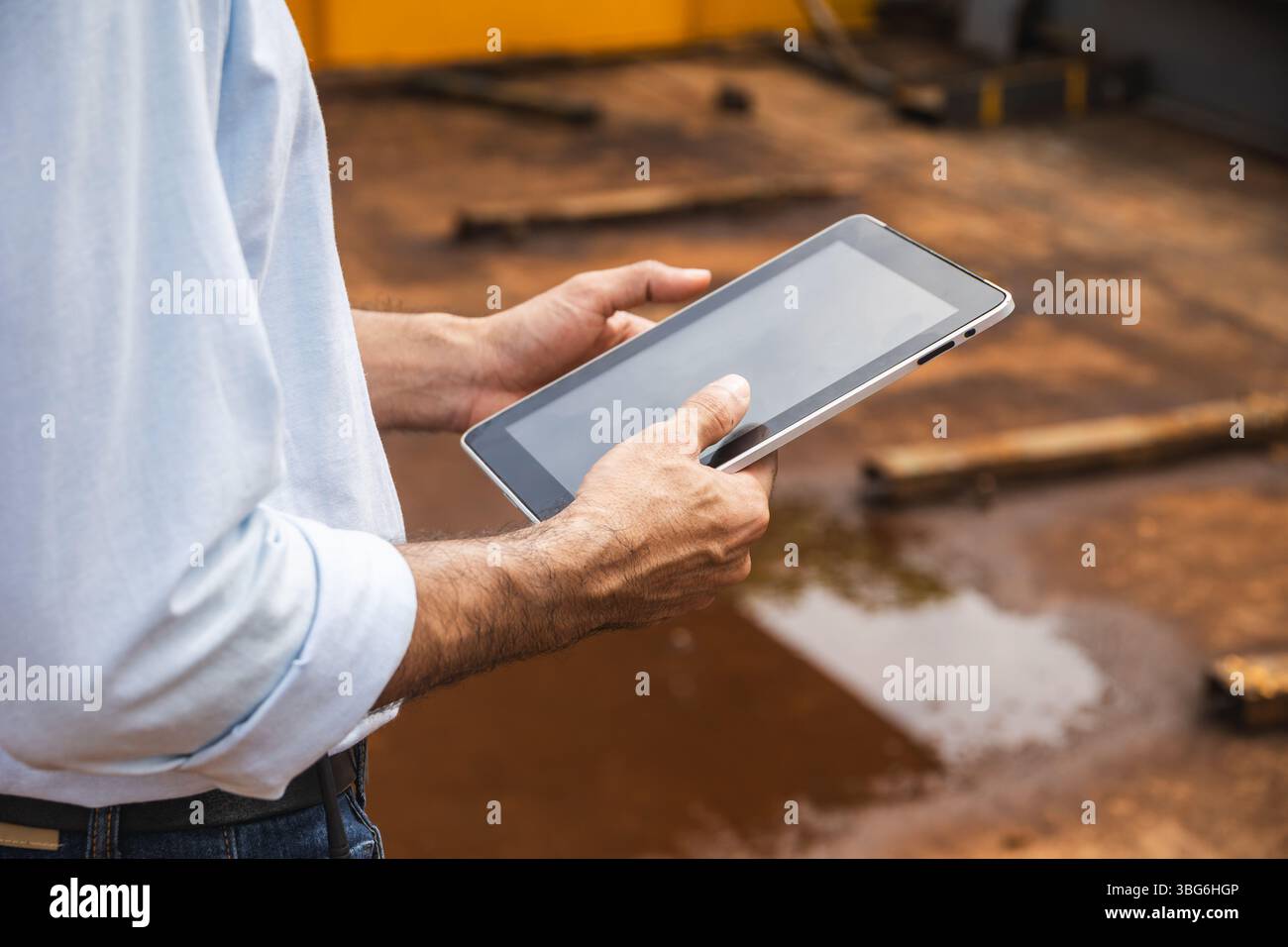 Closeup construction engineer male worker hand holding tablet computer ...