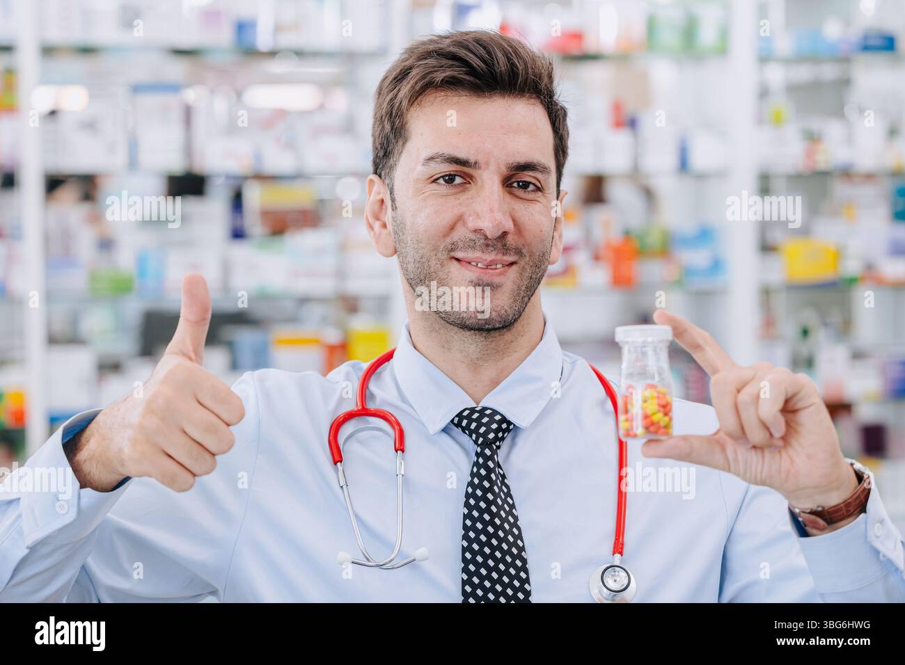 Happy Doctor Pharmacist man in drug store hand holding medicine capsule ...