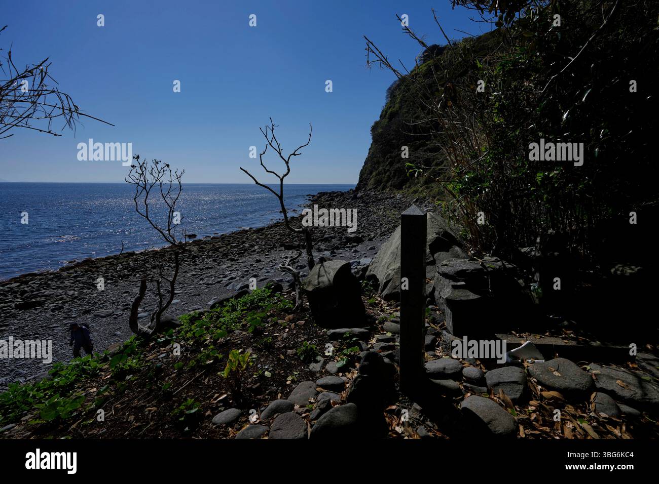 A fisherman, left, walks on a seashore of Ikitsuki island in Hirado ...