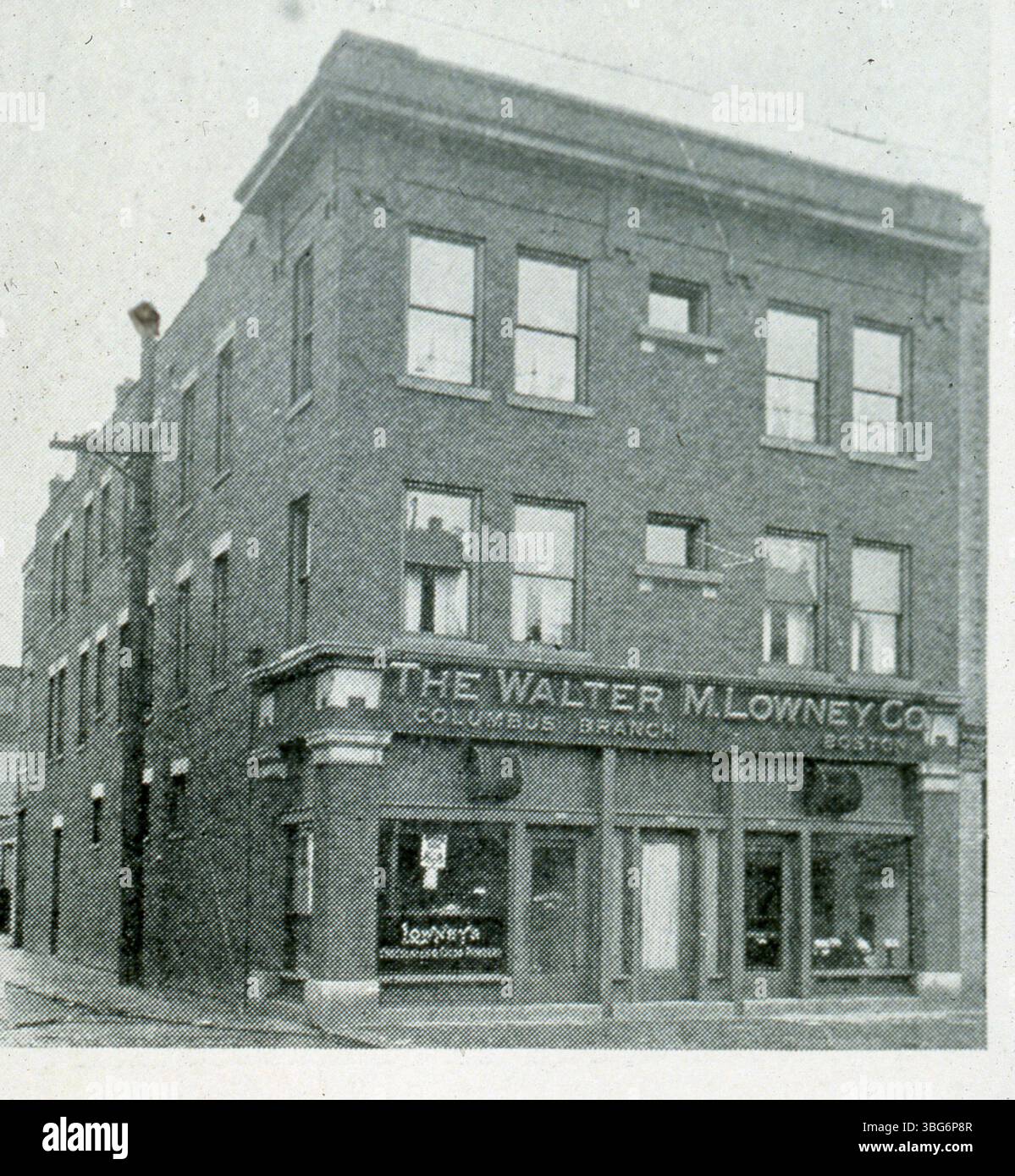 This 1919 photograph shows the Walter M. Lowney Company building, the ...