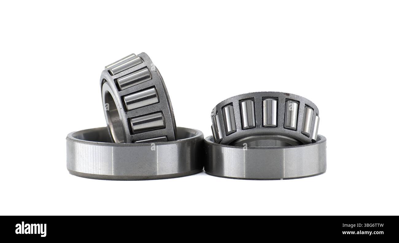 Set of new tapered roller bearings featuring rollers, cages, and races ...