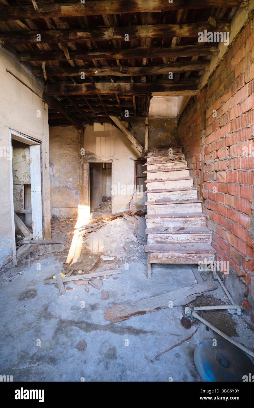 Interior view of a staircase in an old wood house, falling down, beaten ...