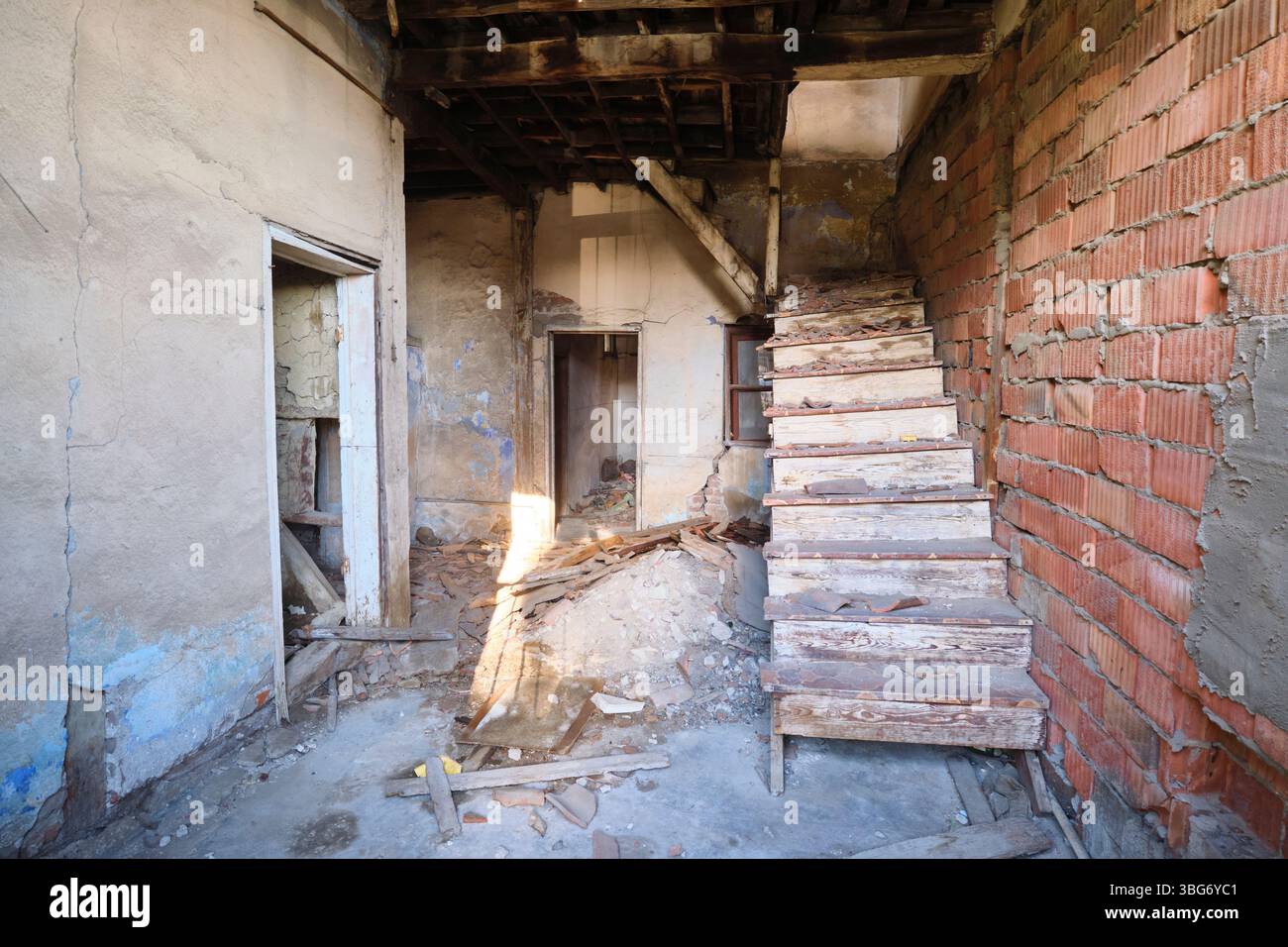 Interior view of a staircase in an old wood house, falling down, beaten ...