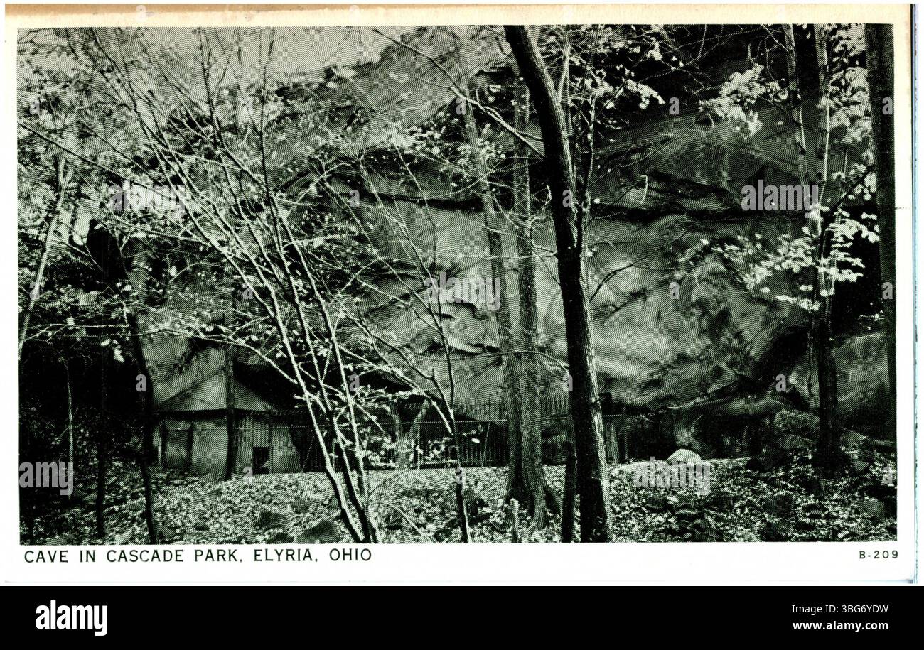 This black and white postcard depicts a cave located in Cascade Park ...