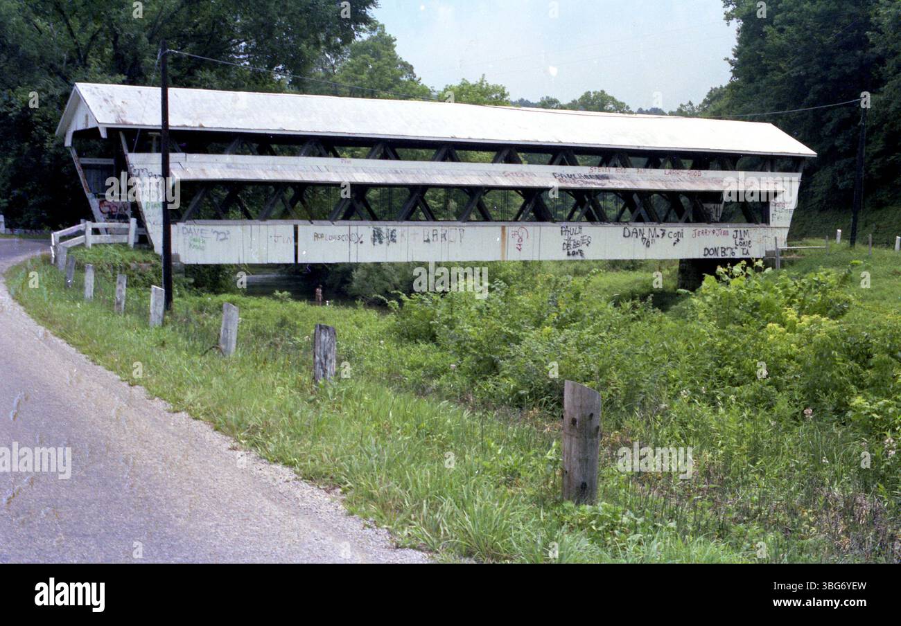 Photograph by A.V. Shirk of a Howe truss covered bridge located in ...