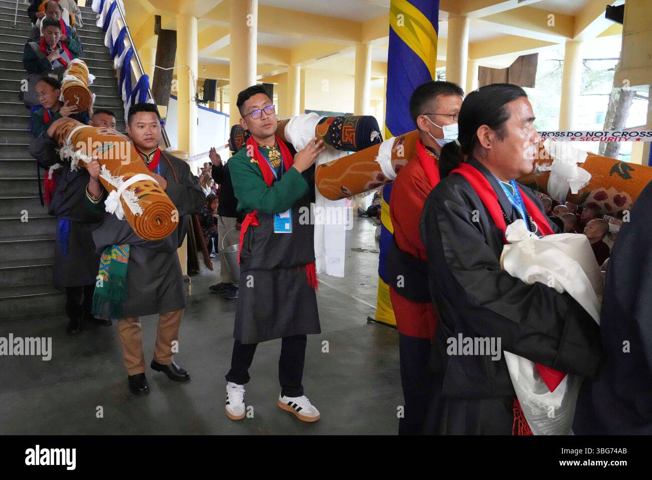 Exiled Tibetans carry ceremonial offerings as they pray for the ...
