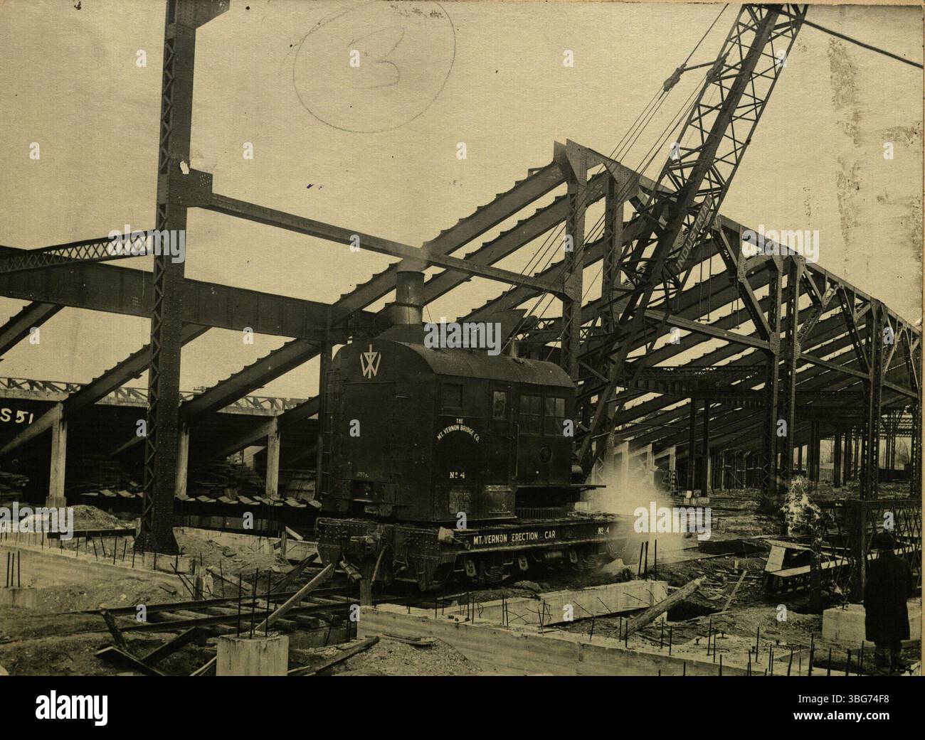 A steam-powered crane is seen hoisting iron girders into place during ...