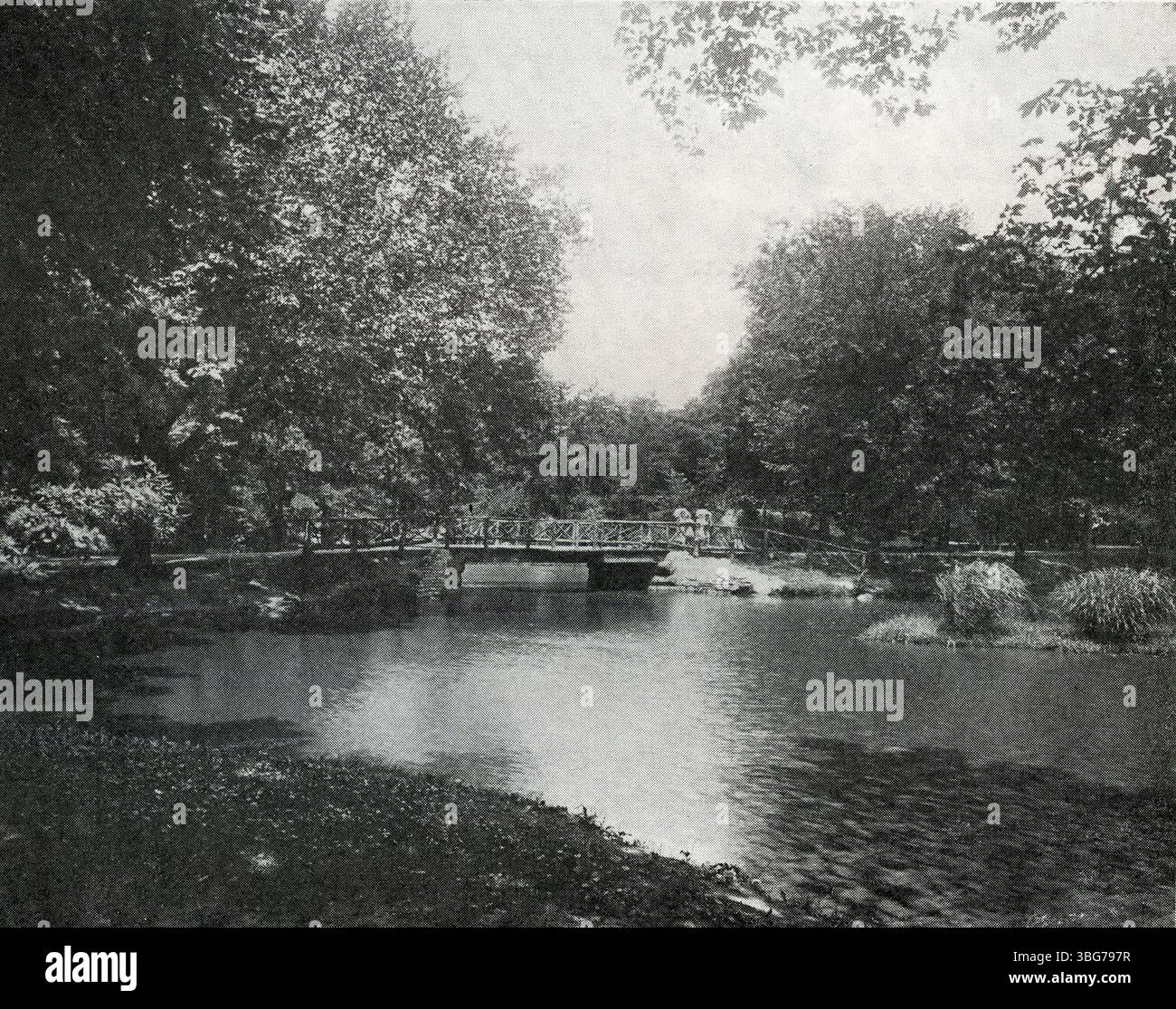 A photograph from 1909 showing the rustic bridge and lake inside Schiller Park, Columbus, which ...