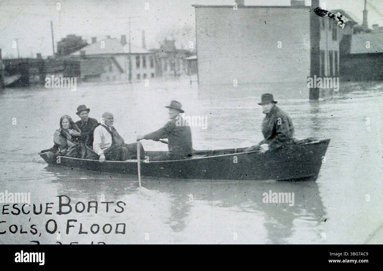 A 1913 photograph showing a man rowing a boat with flood victims ...