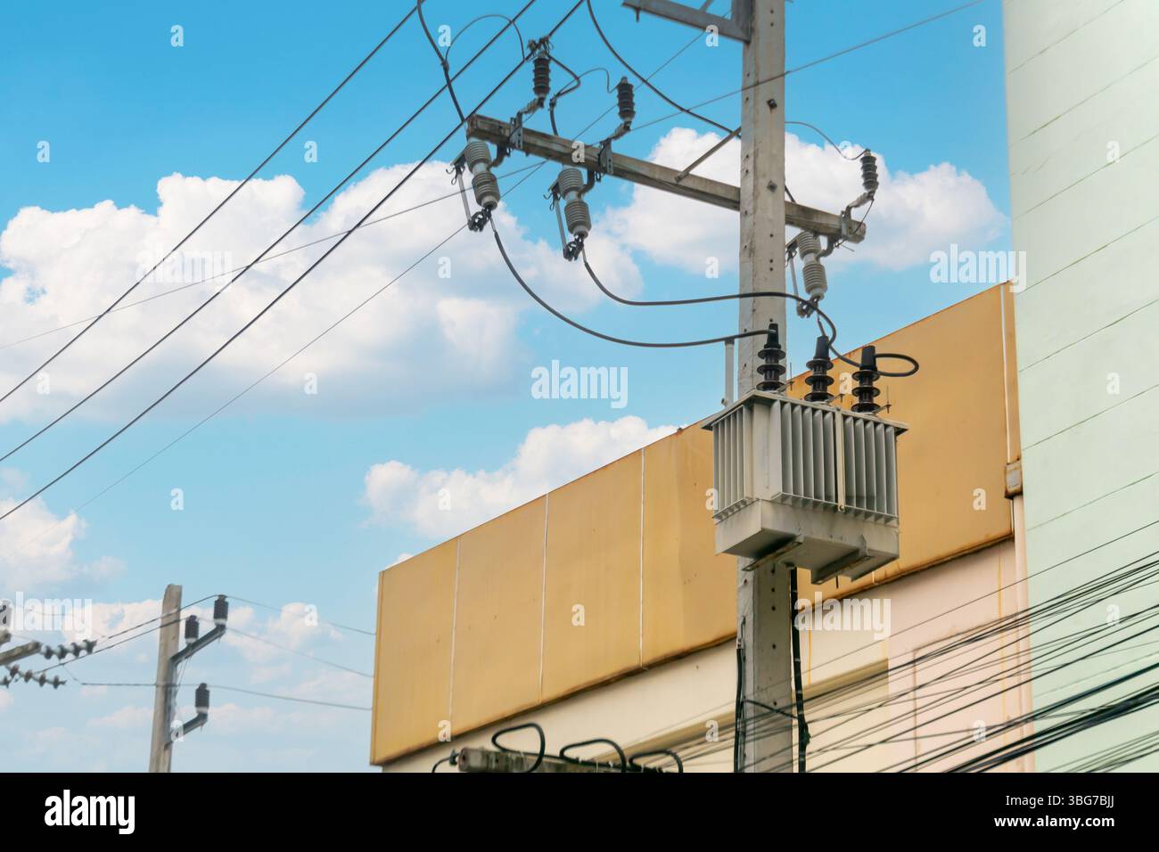 Urban landscape featuring power lines and a transformer with a clear ...