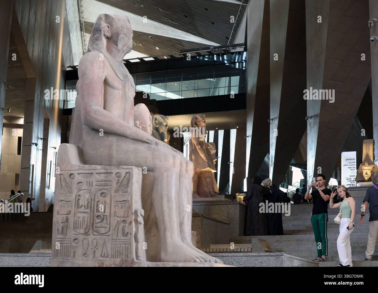 The Grand Egyptian Museum in Egypt Visitors walk past ancient Egyptian ...