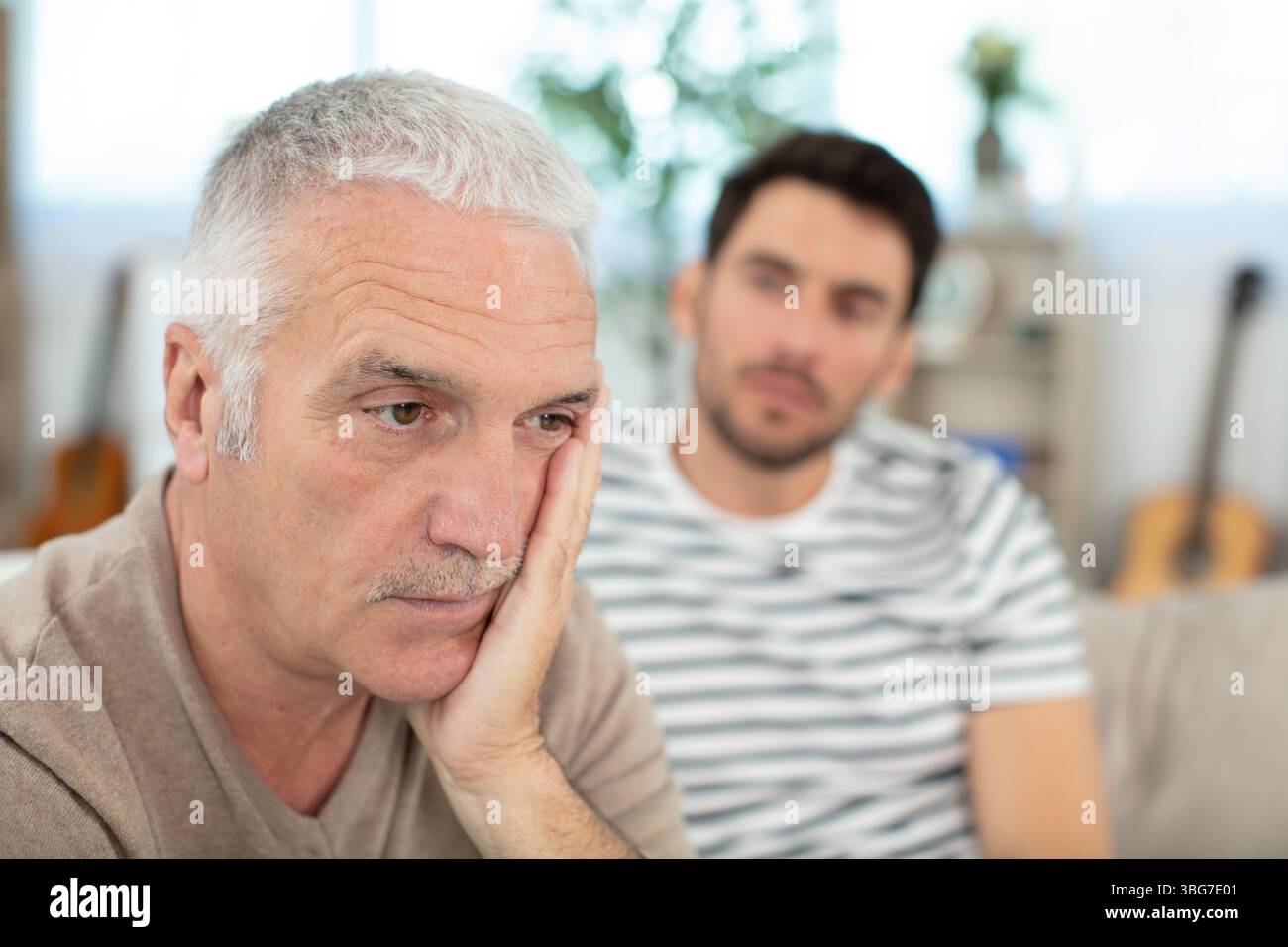 adult son comforting father suffering with dementia Stock Photo - Alamy