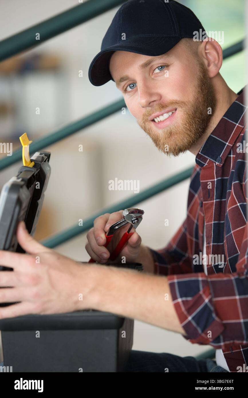 man looking in his tool box Stock Photo - Alamy