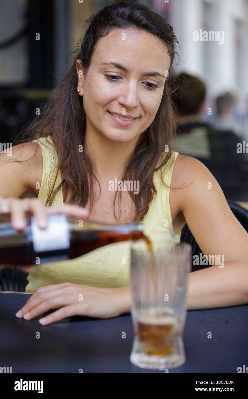 Woman with glass of coke hi-res stock photography and images - Alamy