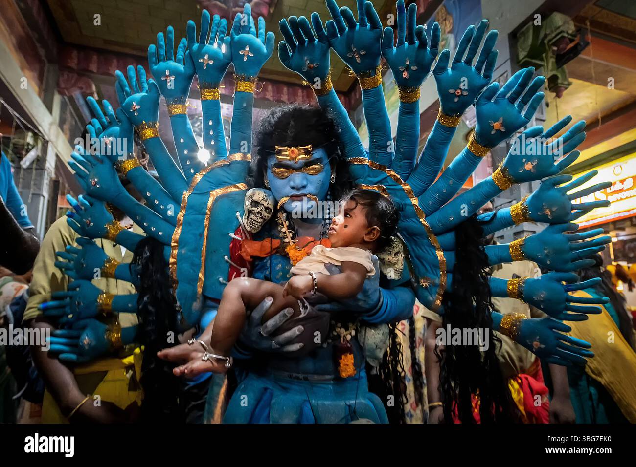 Devotees parade in the Mutharamman temple in Kulasai village, dressed ...