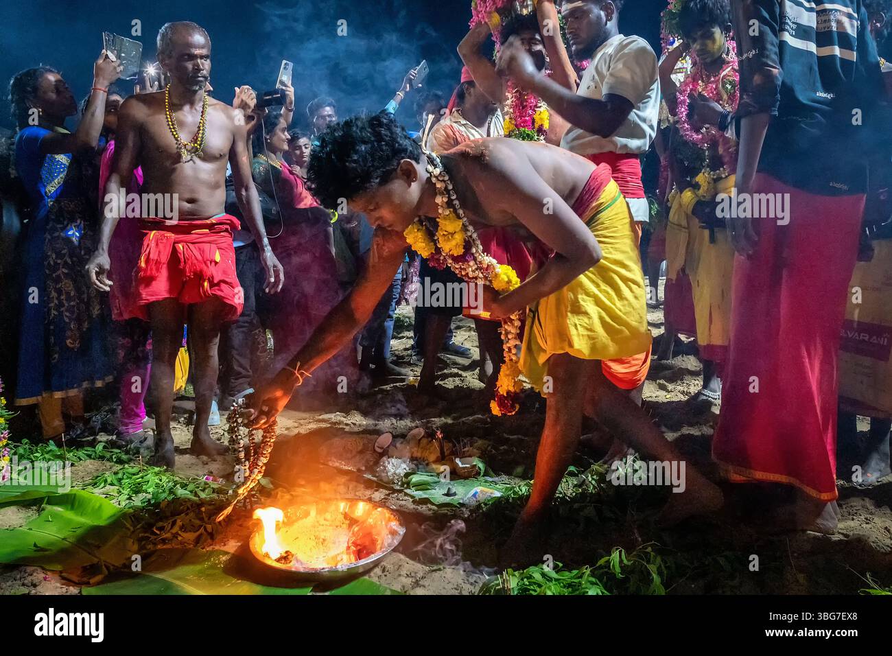 The parade ends in the beach of Kulasai village. The devotees are ...