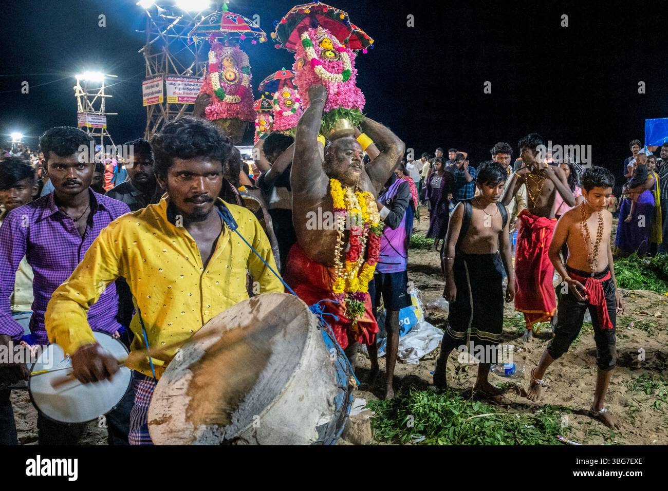 The parade ends in the beach of Kulasai village. The devotees are ...