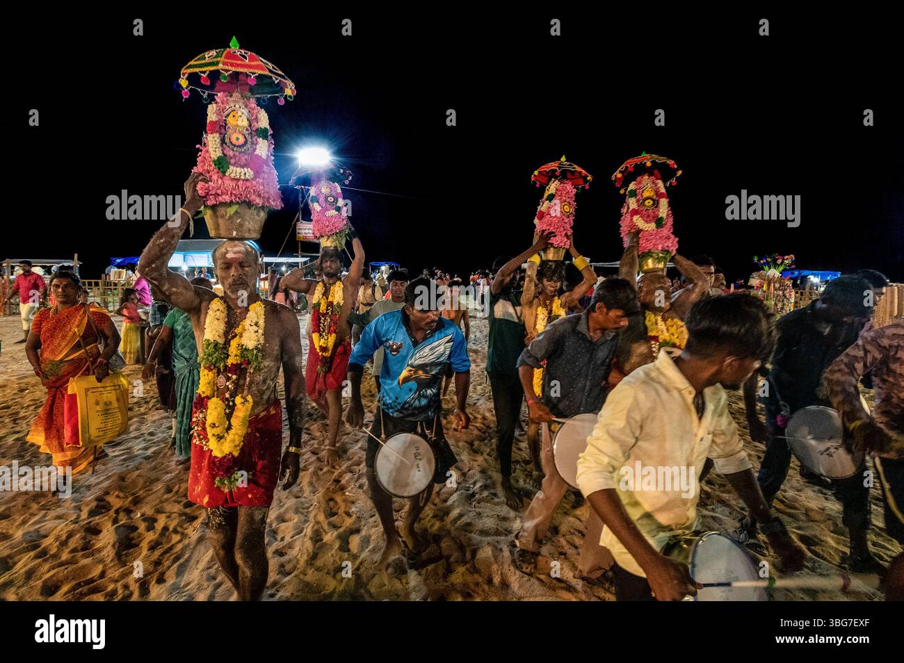 The parade ends in the beach of Kulasai village. The devotees are ...