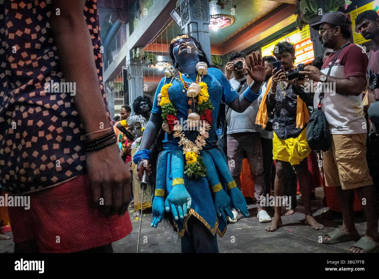 Devotees parade in the Mutharamman temple in Kulasai village, dressed ...