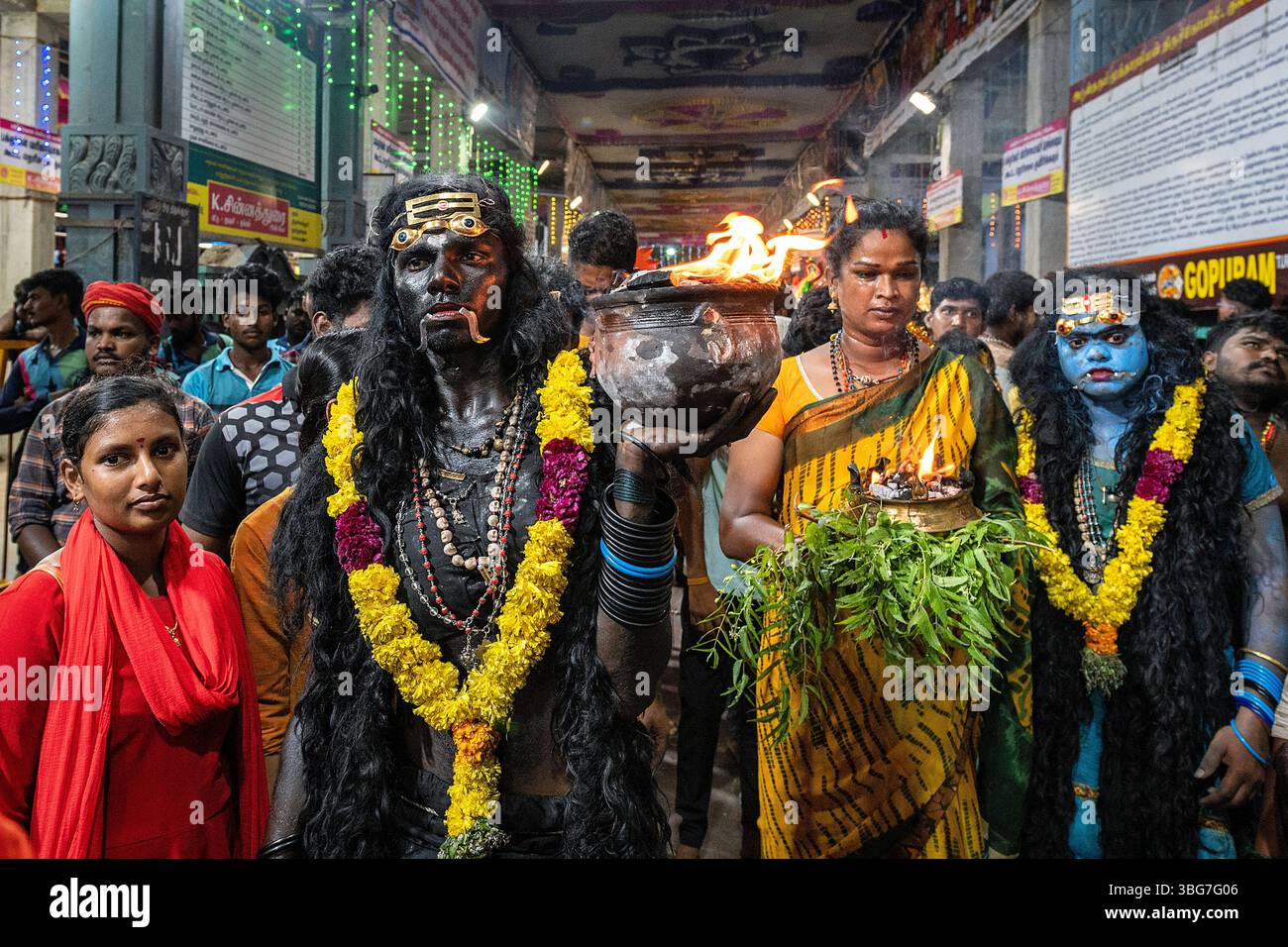 Devotees parade in the Mutharamman temple in Kulasai village, dressed ...