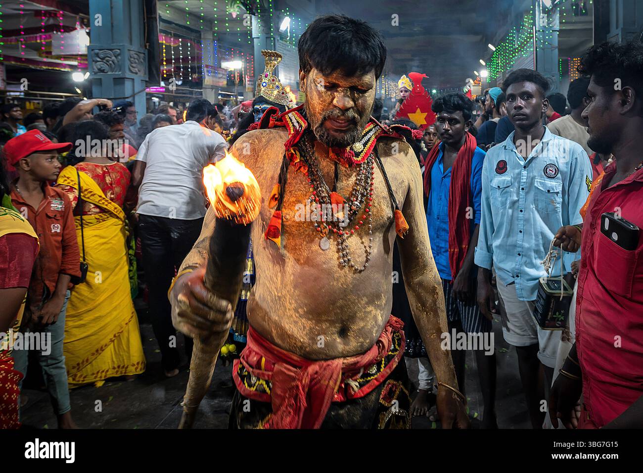 Devotees parade in the Mutharamman temple in Kulasai village, dressed ...