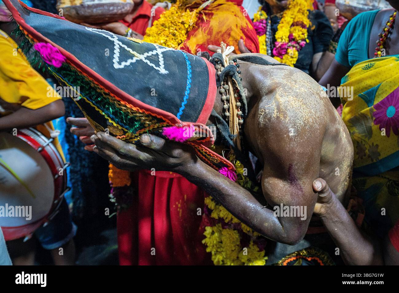 Devotees parade in the Mutharamman temple in Kulasai village, dressed ...