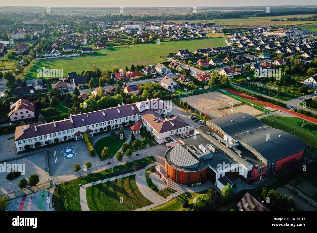 Aerial view of large school complex with classrooms, gymnasium, sports ...