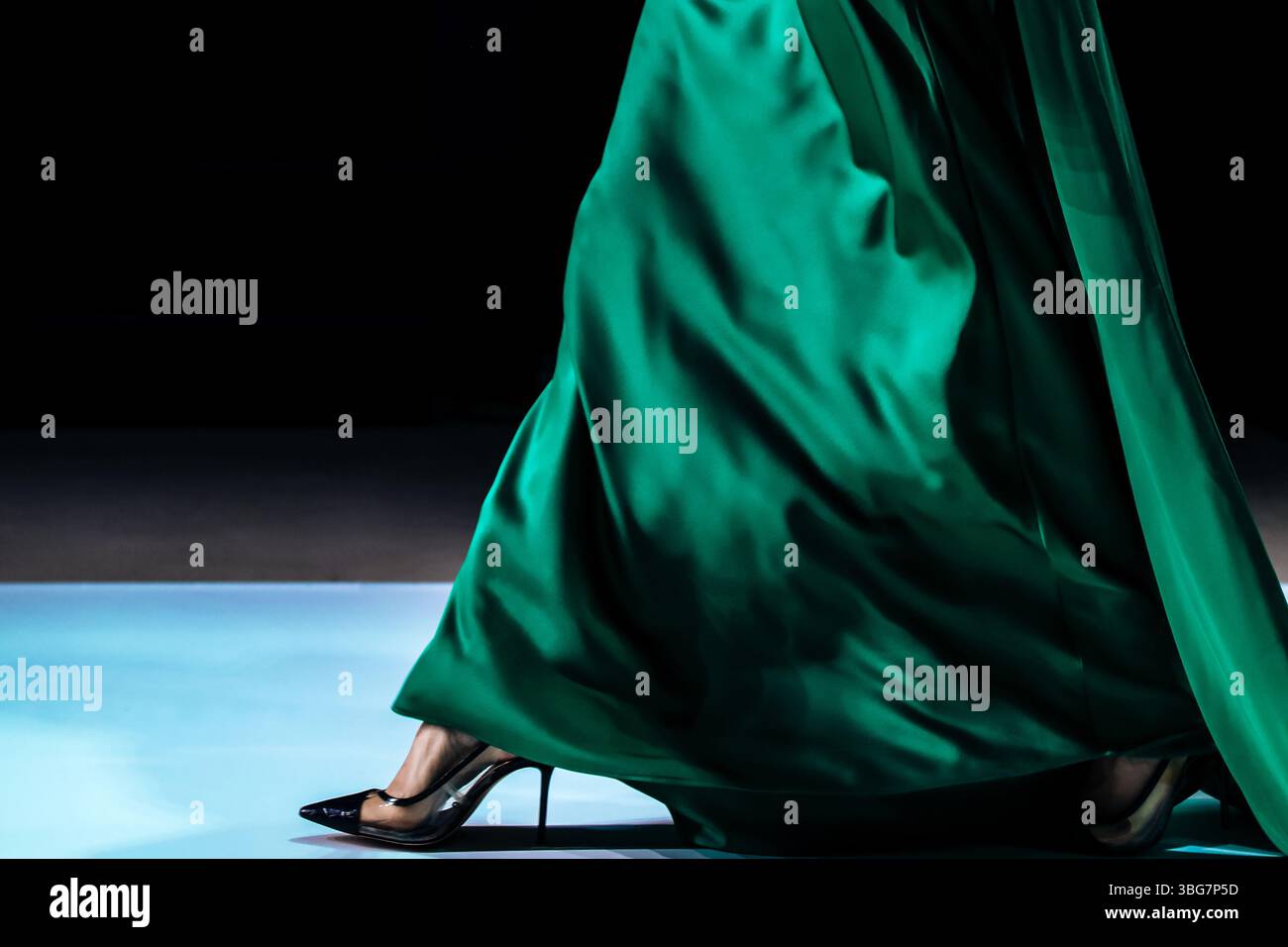 Silk green long skirt and lack high heels. Fashion model walking runway ...