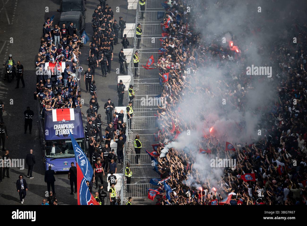 Paris Saint-Germain's supporters wave as the PSG team bus parades on ...