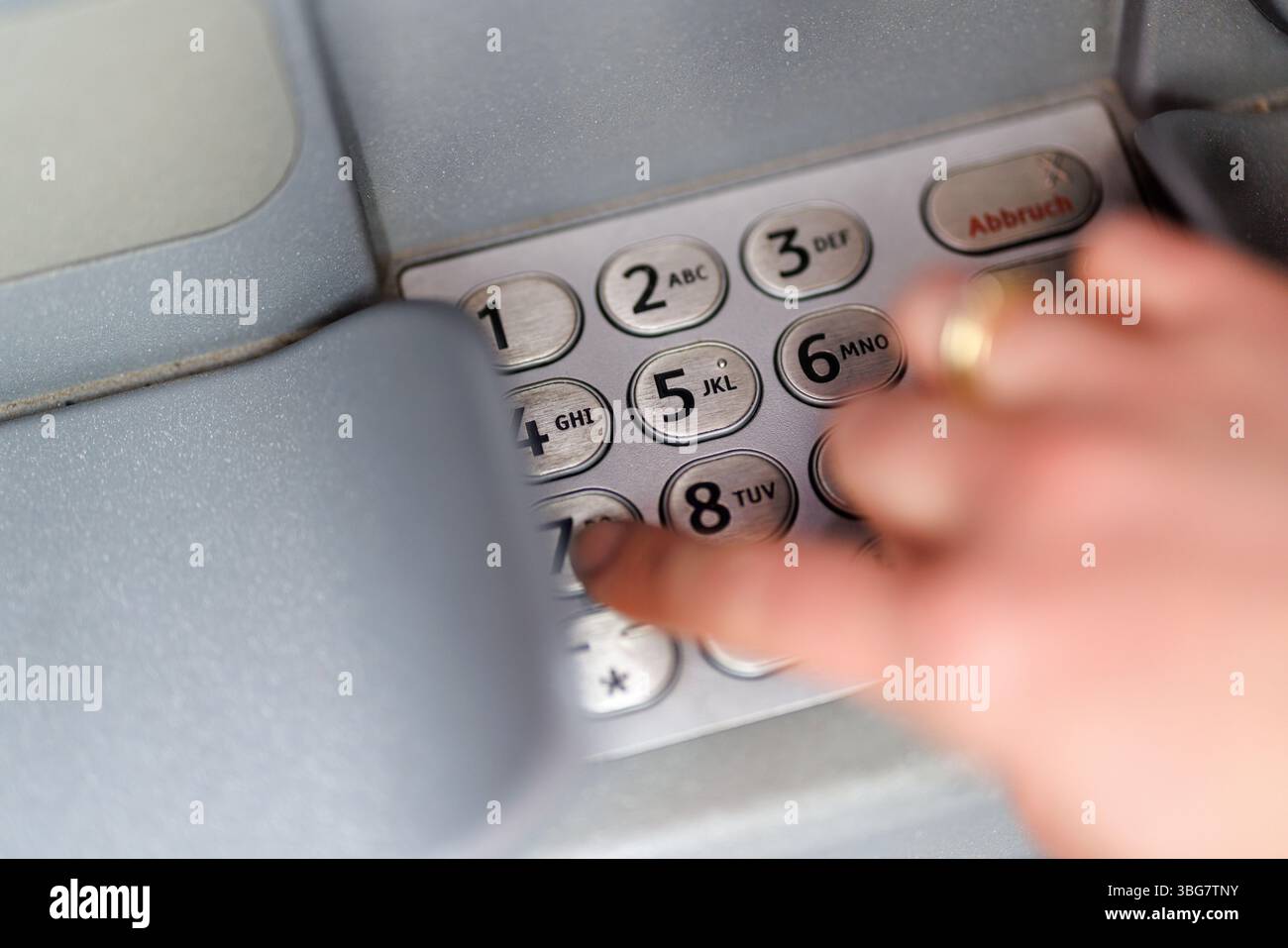 29 May 2025, Bavaria, Munich: A woman operates an open ATM on the ...