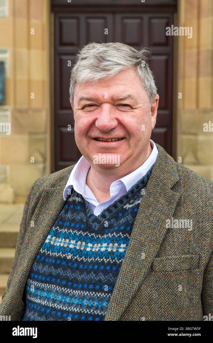 MP Alistair Carmichael stands outside Lerwick Town Hall, engaging with ...