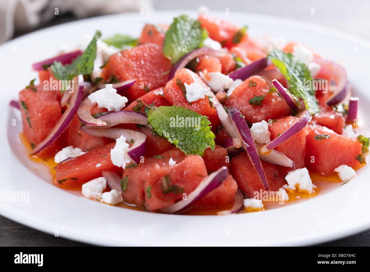 Fresh Watermelon Feta Salad with Mint and Red Onion on wooden table ...