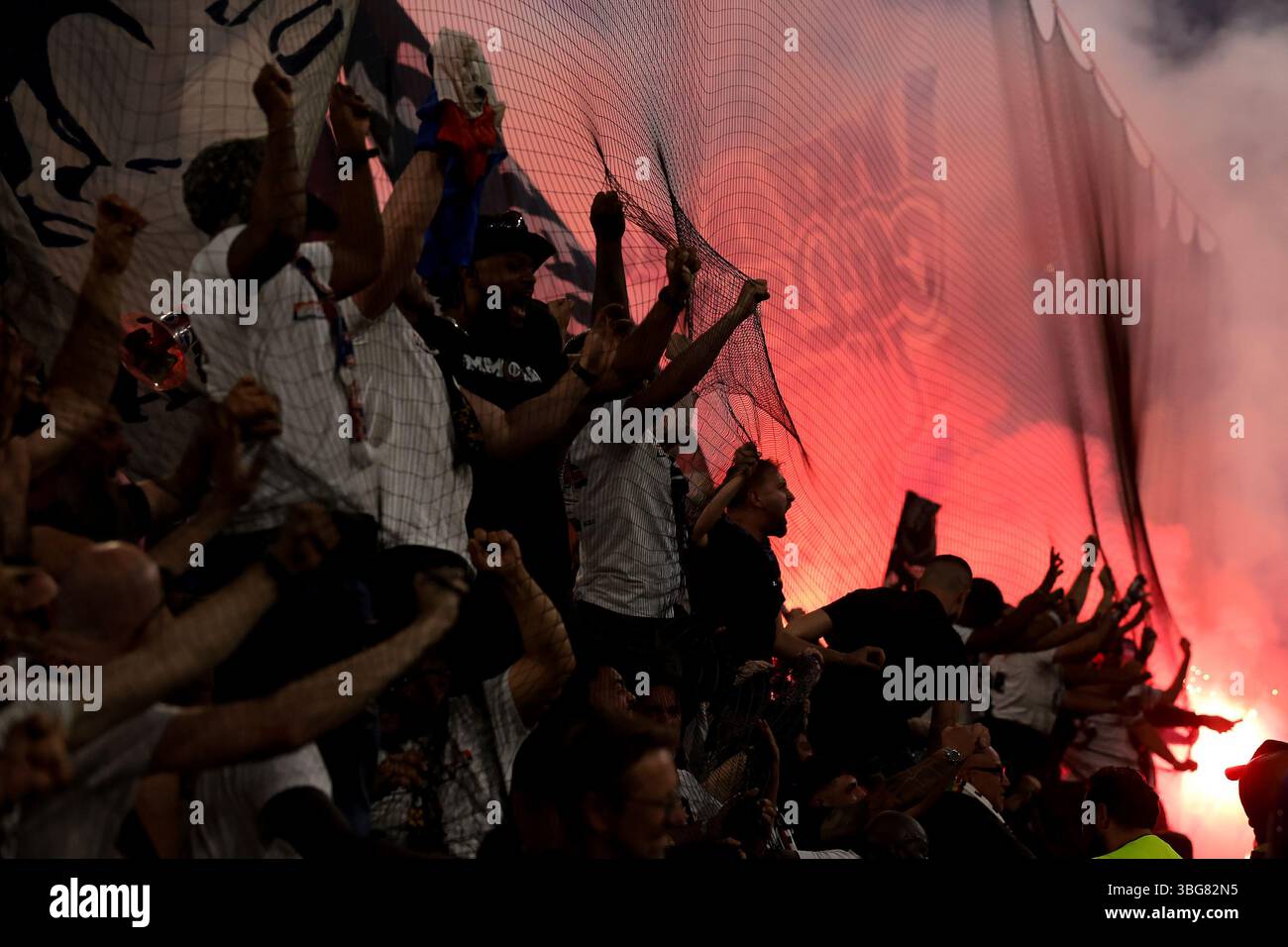 Munich, Germany. 31st May, 2025. PSG fans light flares as they ...
