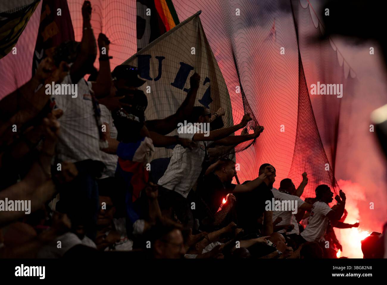 Munich, Germany. 31st May, 2025. PSG fans light flares as they ...