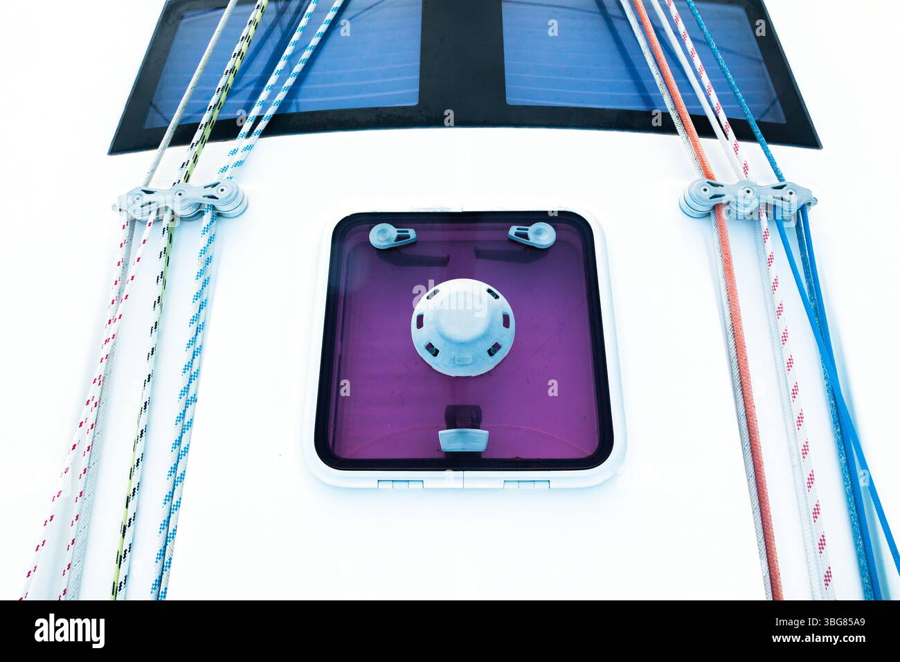 Part of the hull of a sailing yacht with multi-colored ropes, rollers ...