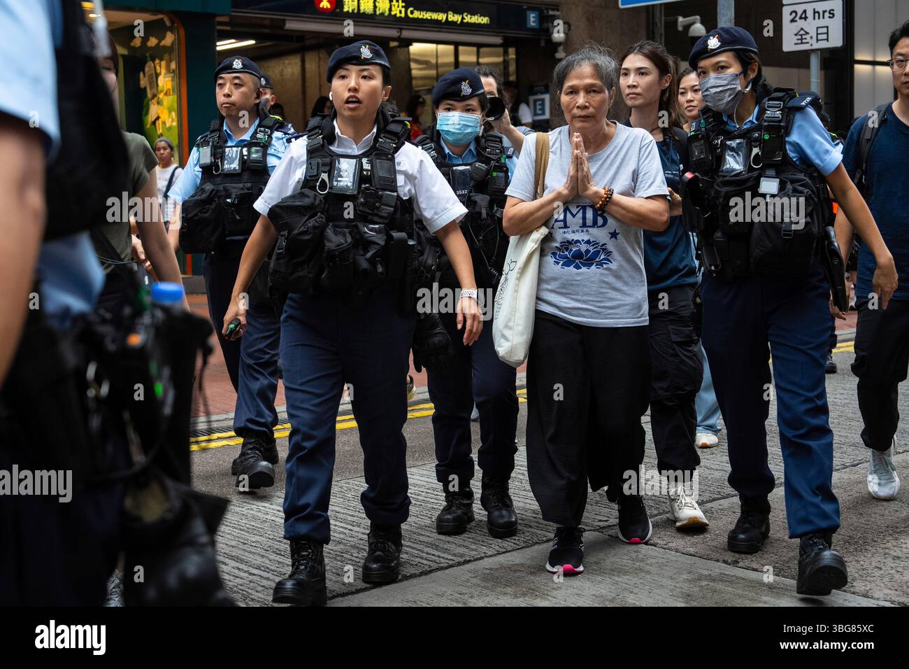 Activist Lui Yuk-lin, center right, is detained by police officers in ...