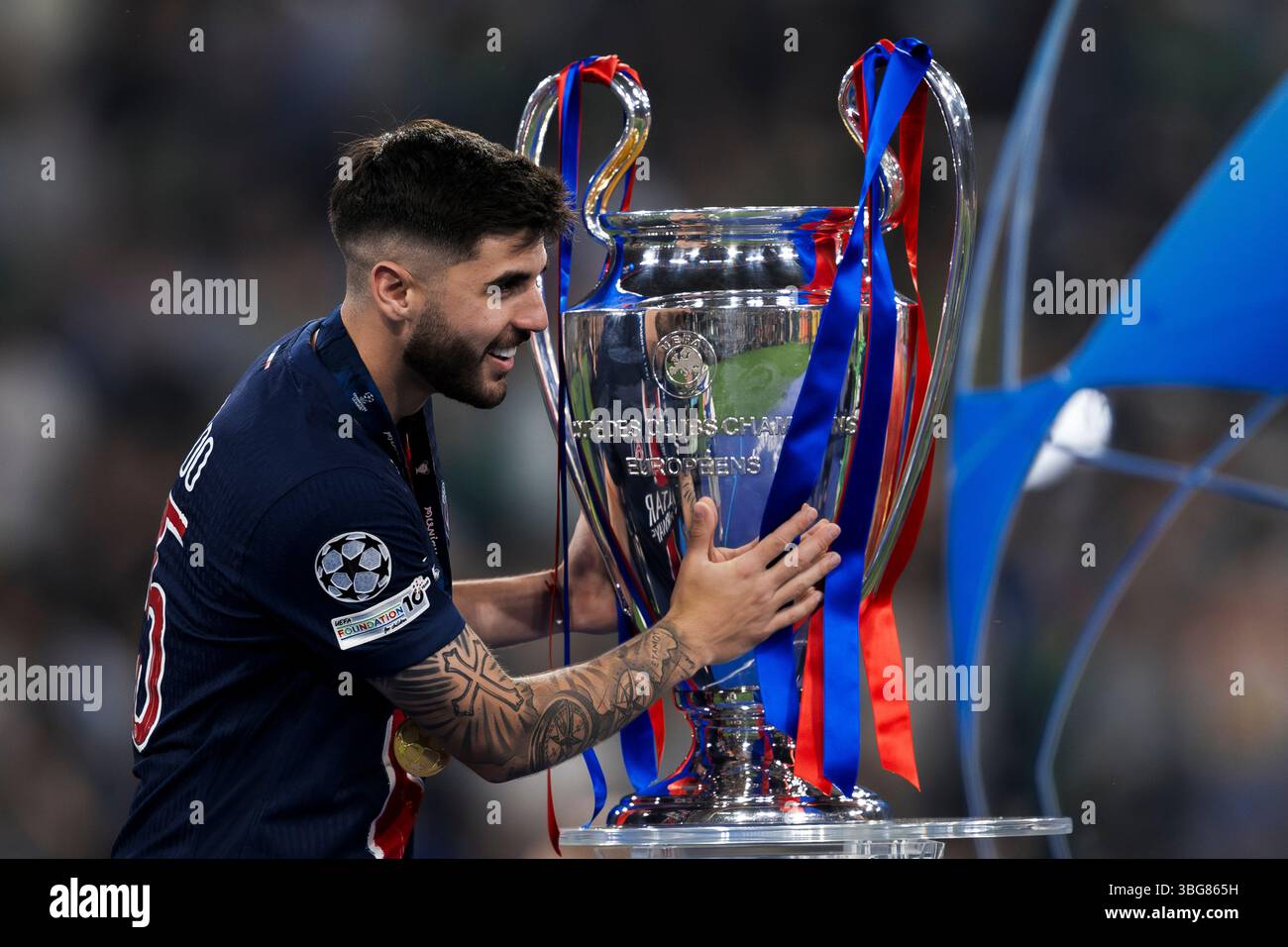 Lucas Beraldo of Paris Saint-Germain FC celebrates with the trophy ...