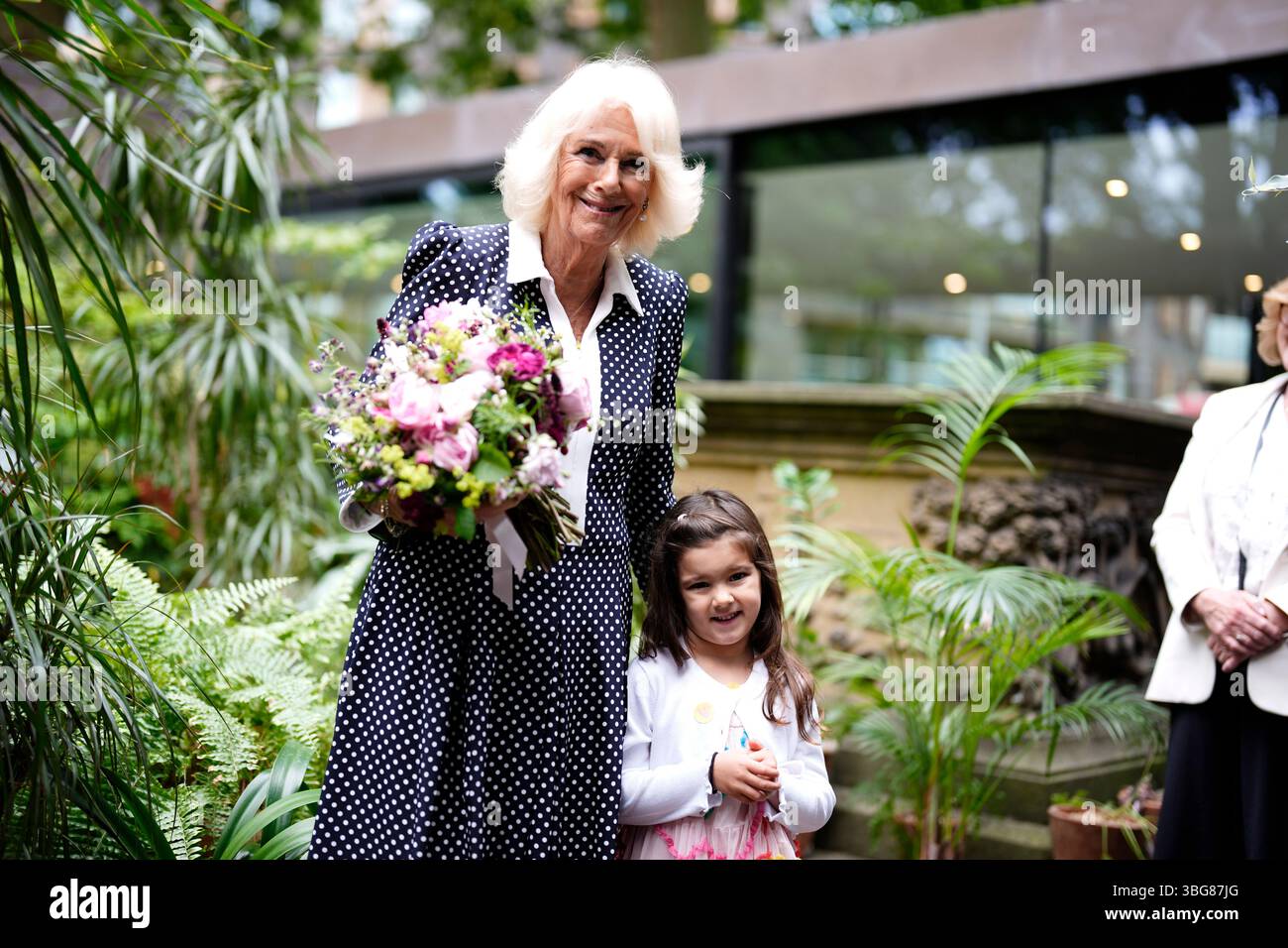 Queen Camilla with Darcie Donaldson, four, during a visit to the ...