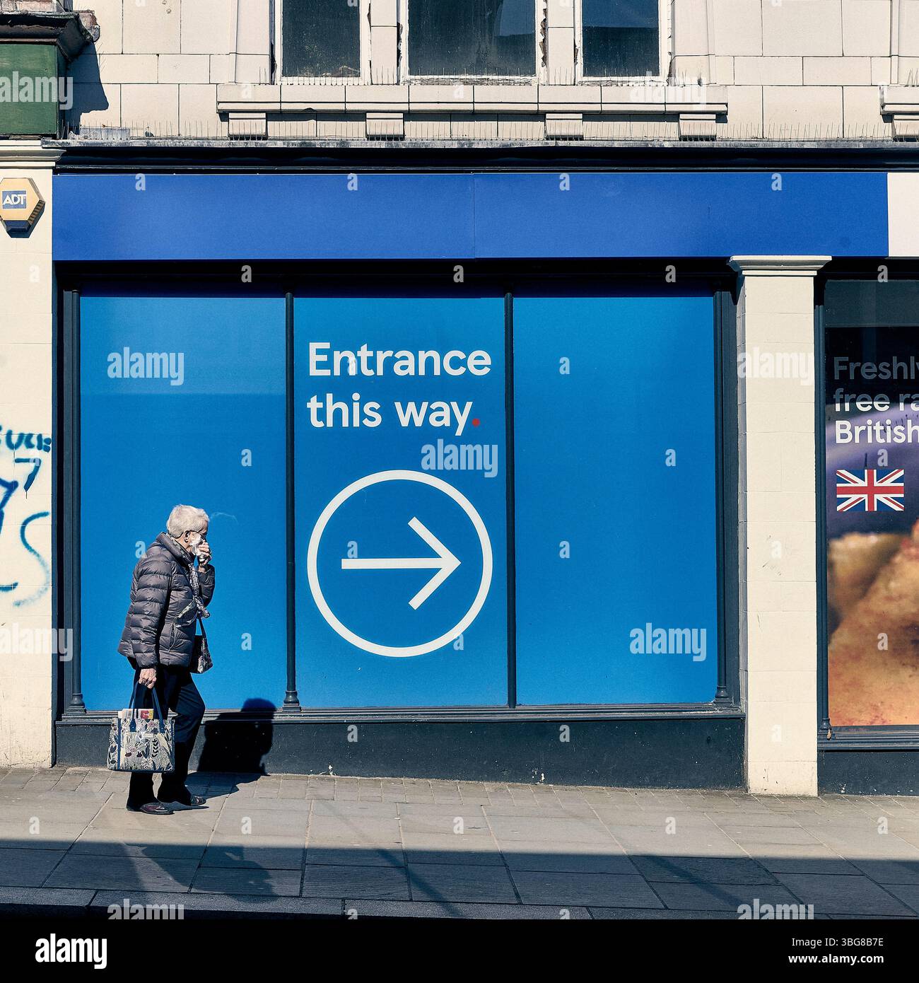 Senior women walking past shop window in Halifax town centre,West ...