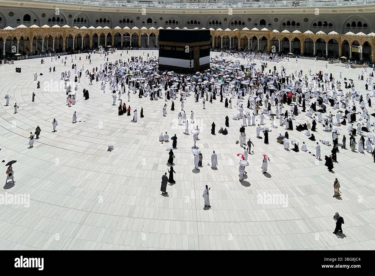 Muslim pilgrims walk around the Kaaba, the cubic building at the Grand ...