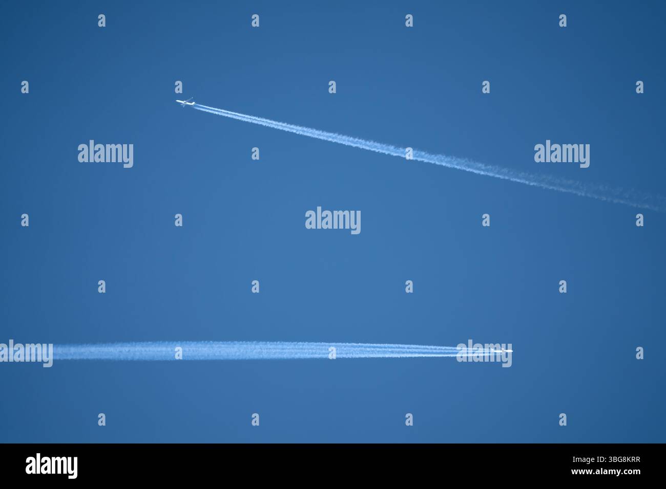 twin engined jet liner aircraft with contrails, in flight at high ...