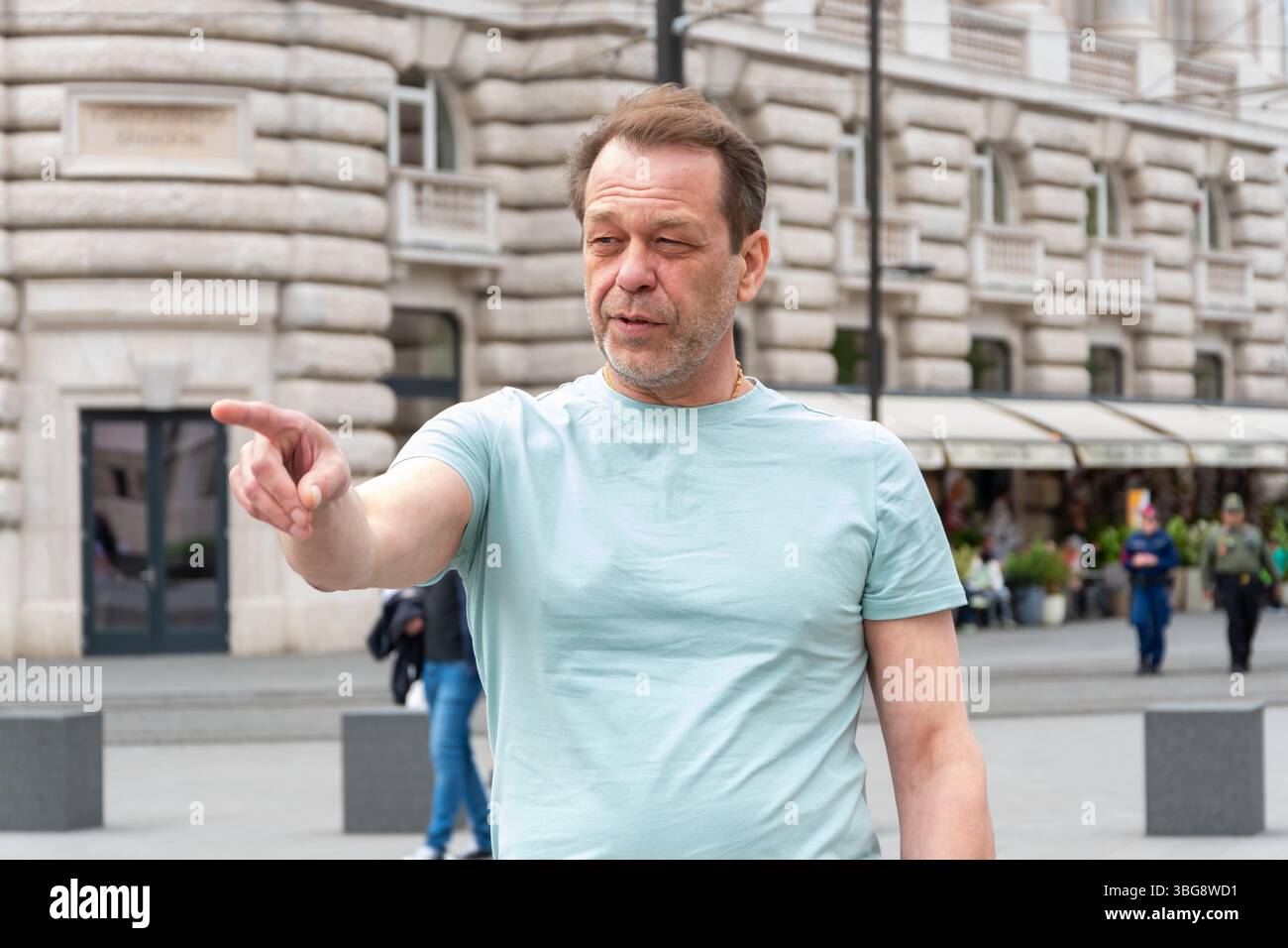 Emotional communication in the city. A man points his finger, perhaps ...