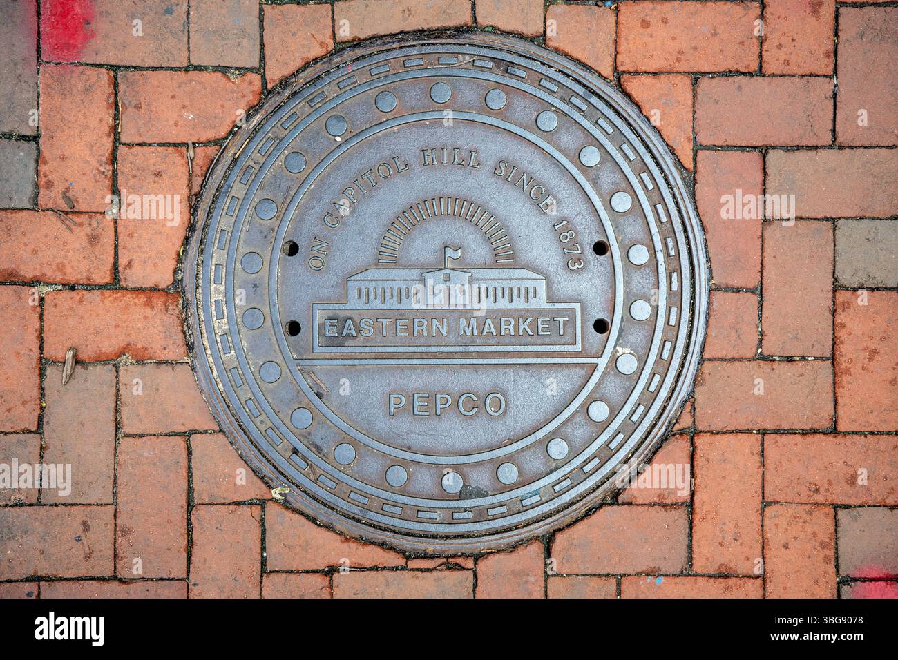 WASHINGTON DC — A decorative manhole cover embedded in a sidewalk on ...