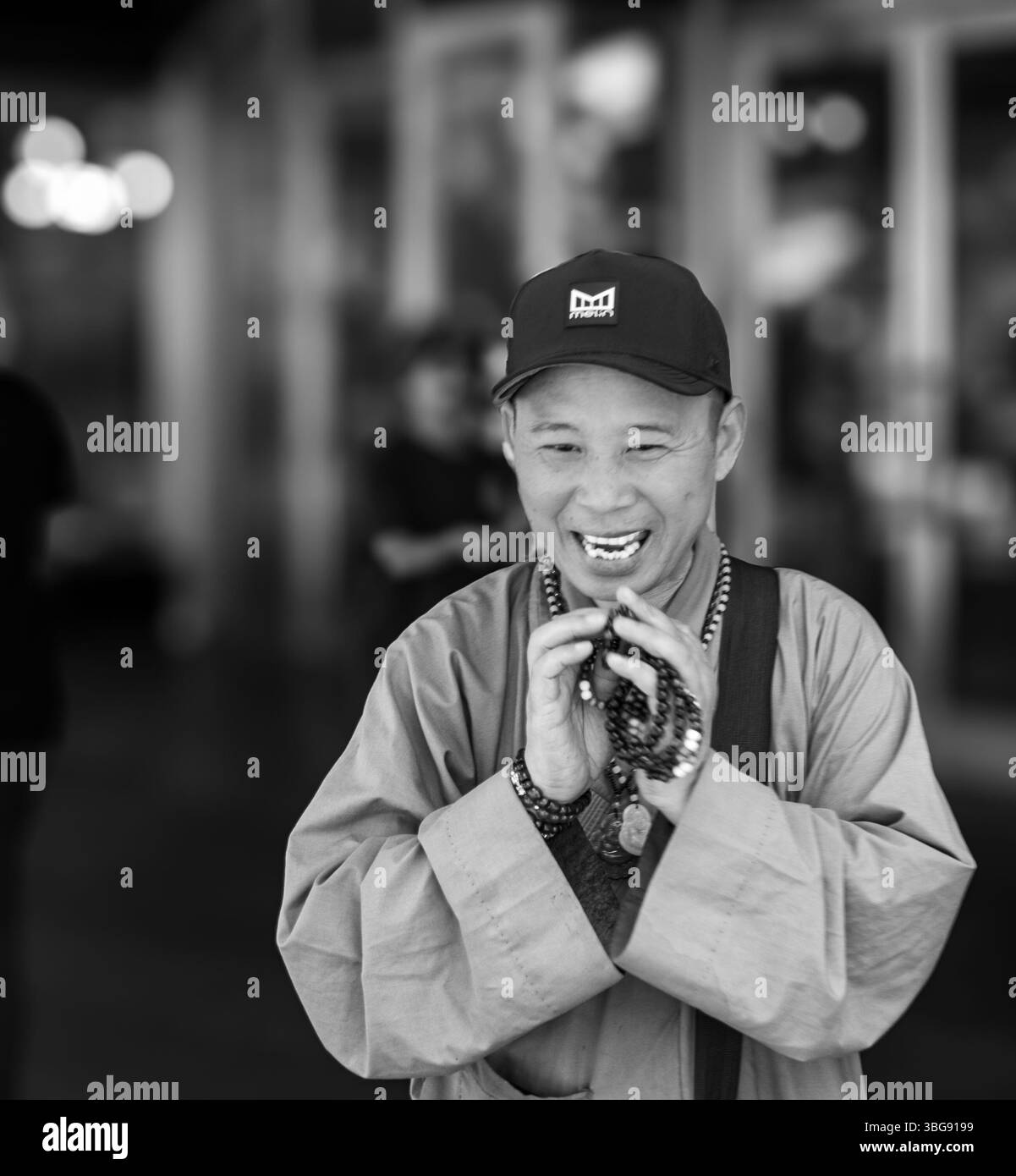 Joyful Man in Traditional Robes Holding Prayer Beads, Street Portrait ...
