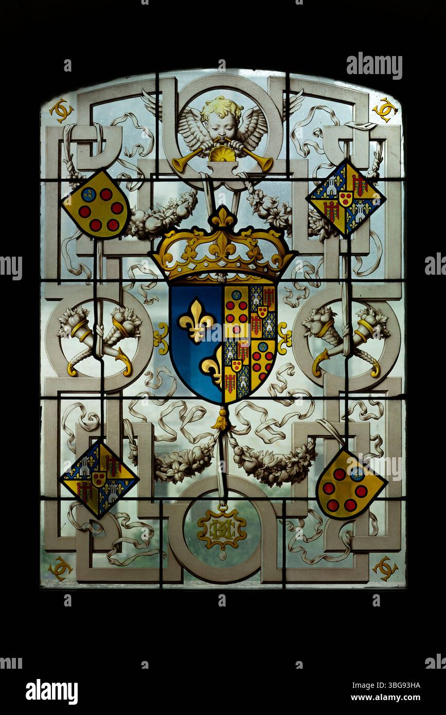 Magnificent stained glass window displays heraldic emblems and colorful ...