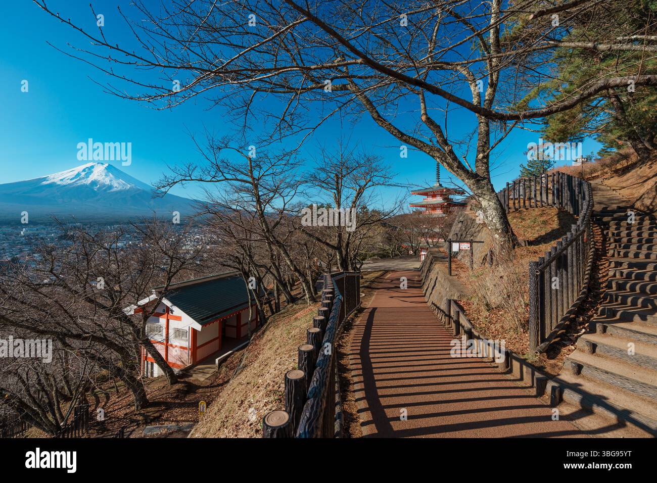 A winding path leads past a shrine building towards the iconic Chureito ...
