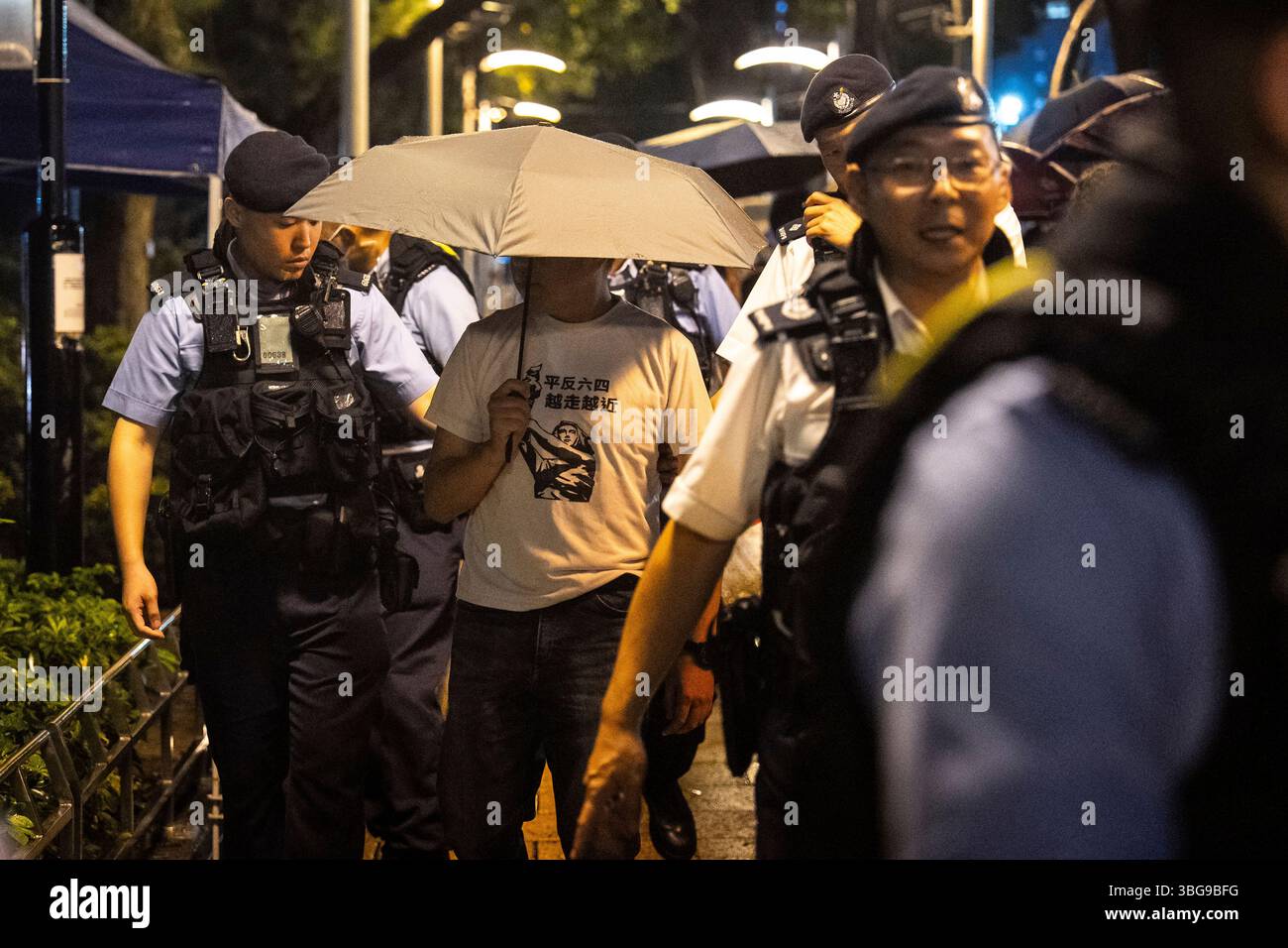 A man wearing a white T-shirt printed with Chinese words "Vindication ...