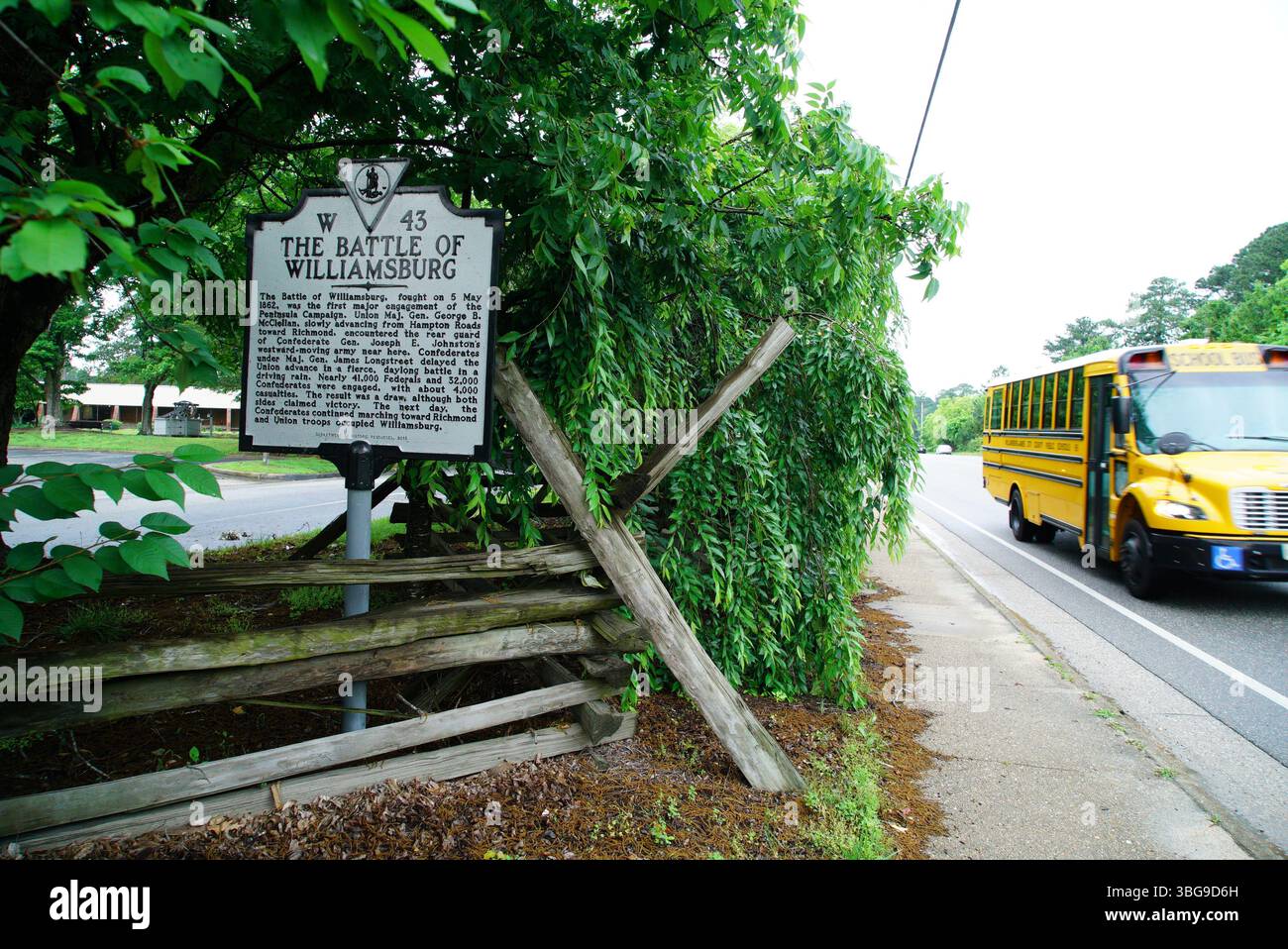 A school bus passes a historical marker for The Battle of Williamsburg ...